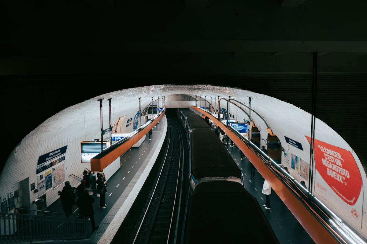 Commuters waiting at a Paris Metro station platform