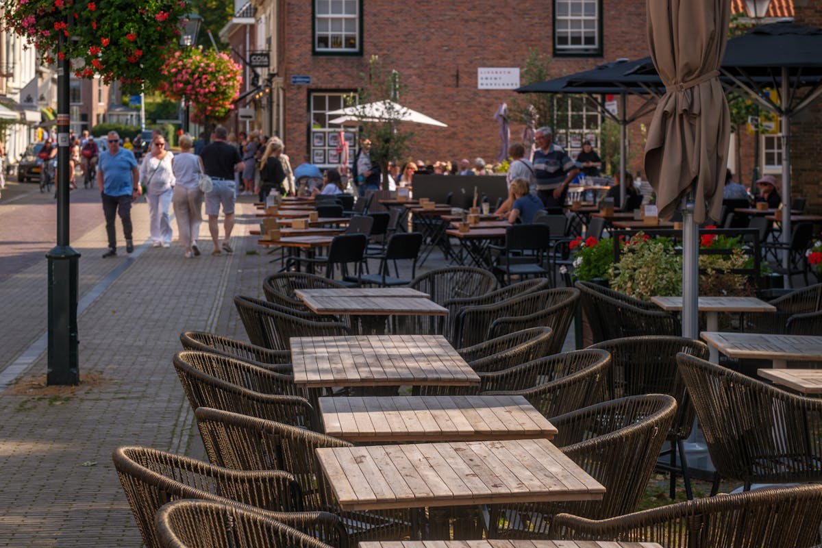 Stylish outdoor cafe seating on a sunny Paris street