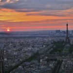 Stunning aerial view of Paris with Eiffel Tower prominently visible during golden hour