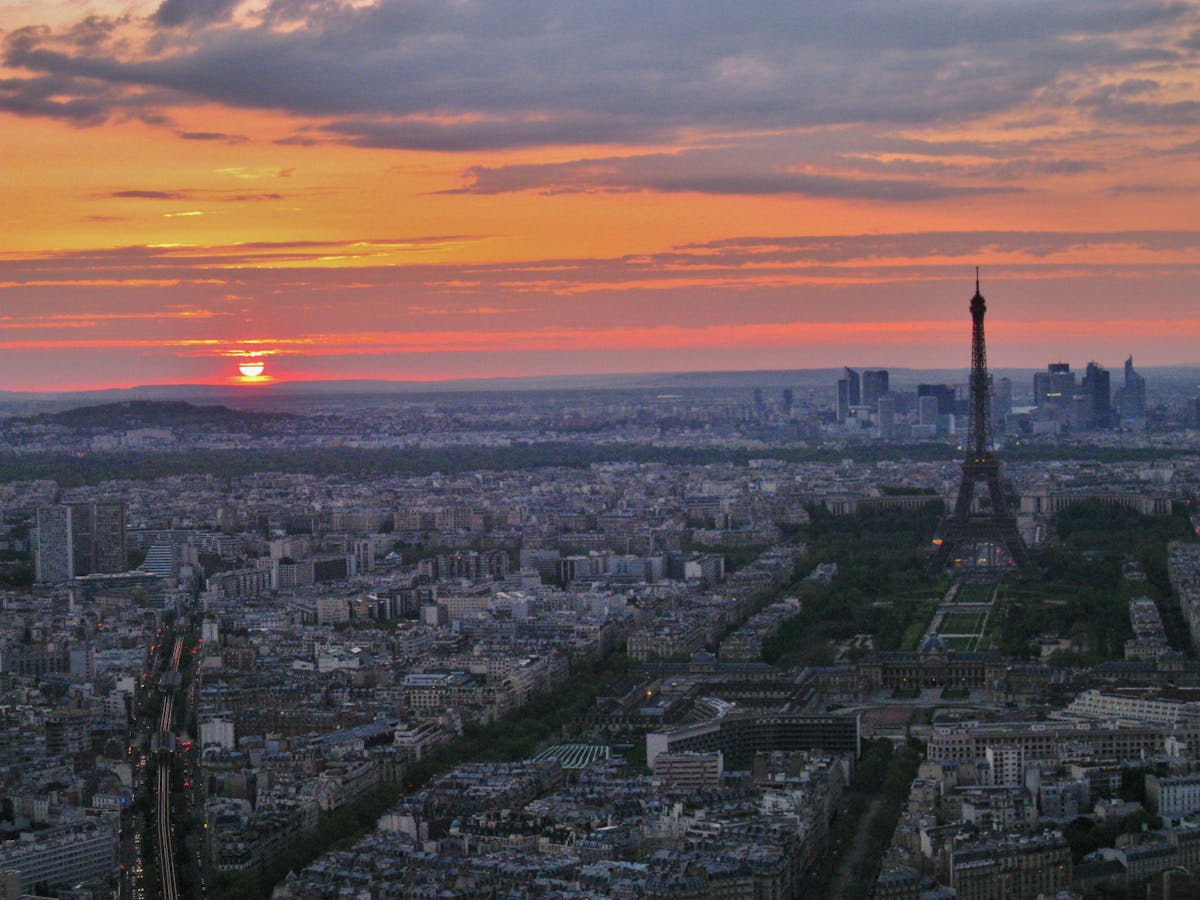 Stunning aerial view of Paris with Eiffel Tower prominently visible during golden hour