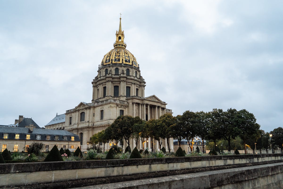 Iconic golden dome of Les Invalides monument in Paris with autumn trees in the foreground