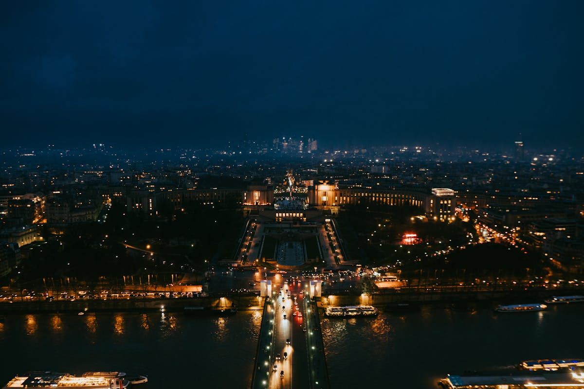 Paris at night from above showing illuminated streets and landmarks
