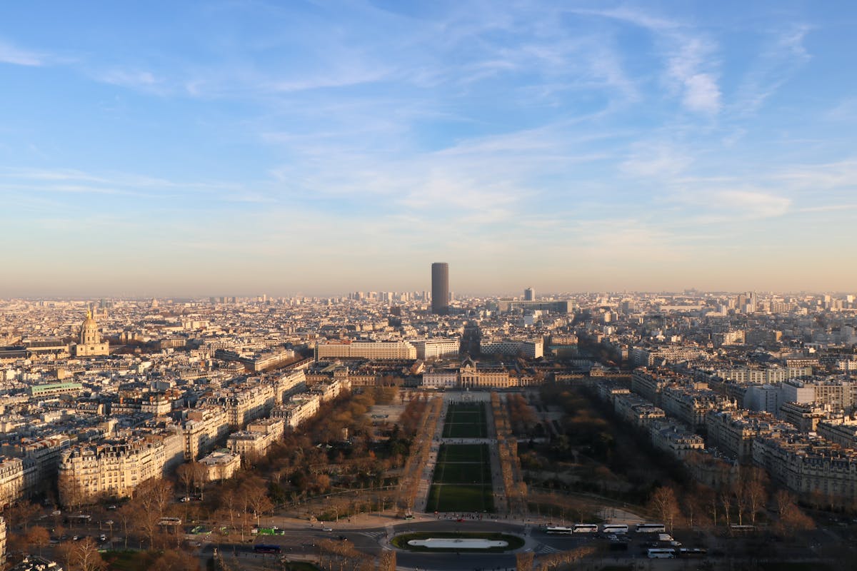 Wide panoramic view of Paris cityscape during golden hour sunset