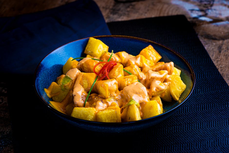 Patatas bravas with spicy sauce served in a traditional Spanish dish