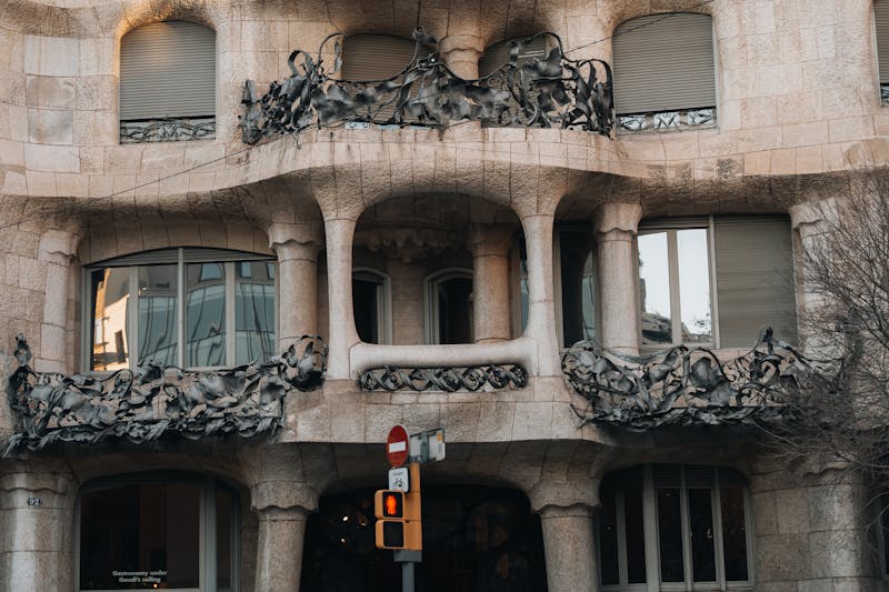 Close-up of the wavy stone facade and wrought-iron balconies of La Pedrera Casa Mila in Barcelona