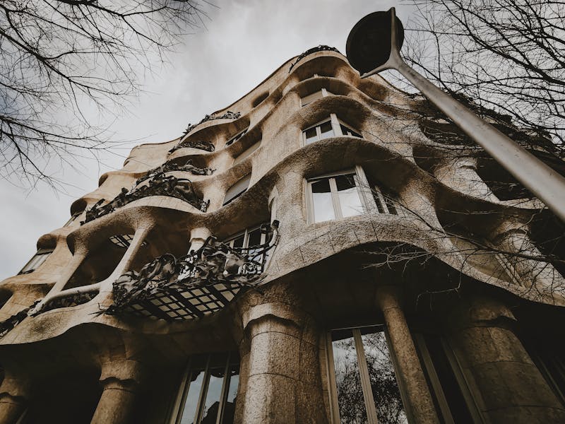 Low angle view showing the wavy organic facade of La Pedrera Casa Mila in Barcelona