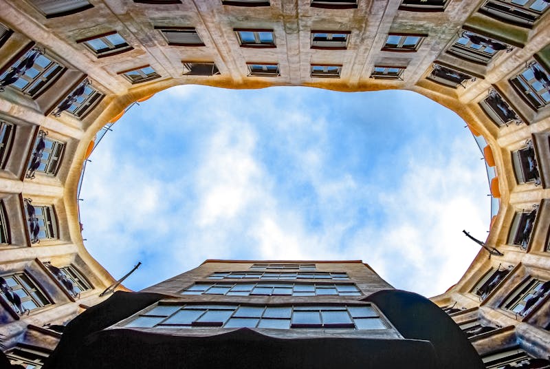 Interior courtyard of Casa Mila La Pedrera looking up at the sky from inside the building