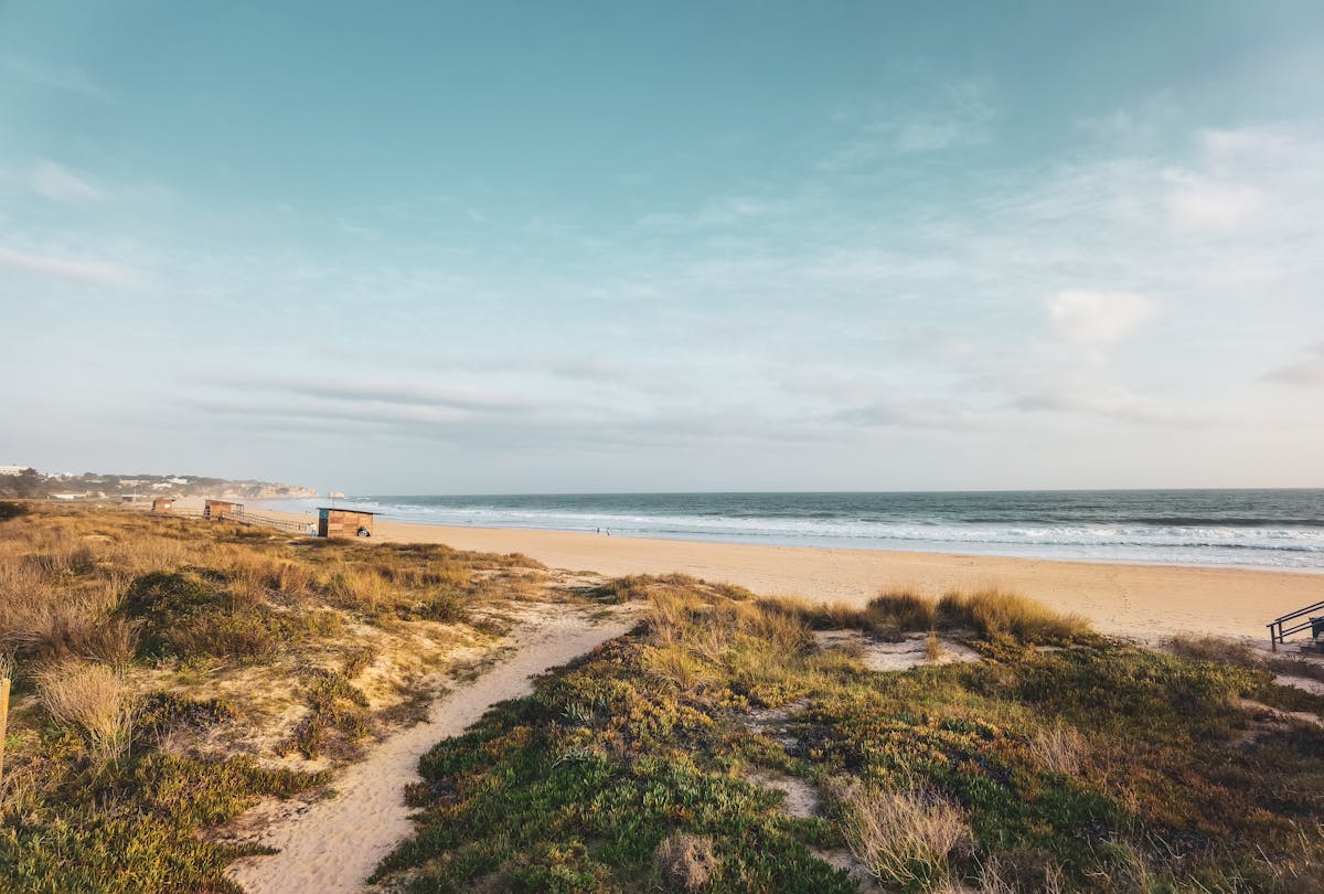 Serene Faro coastal beach with ocean waves sand and sky