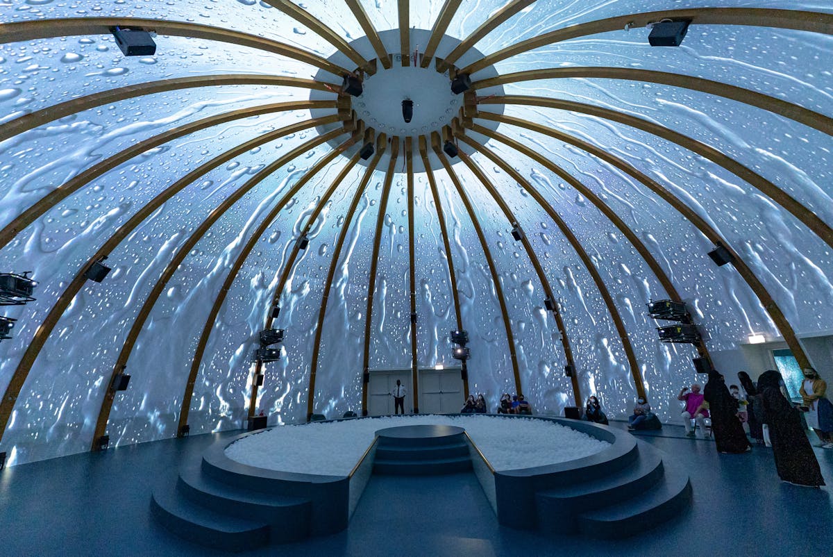 Stunning dome interior with water visuals projected on walls and ceiling in immersive art space