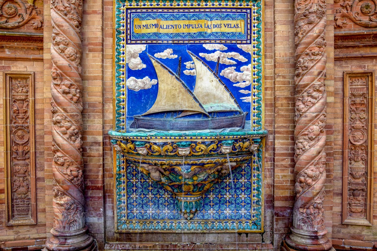 Intricate ceramic tile art depicting a historic sailing ship at Plaza de Espana in Seville