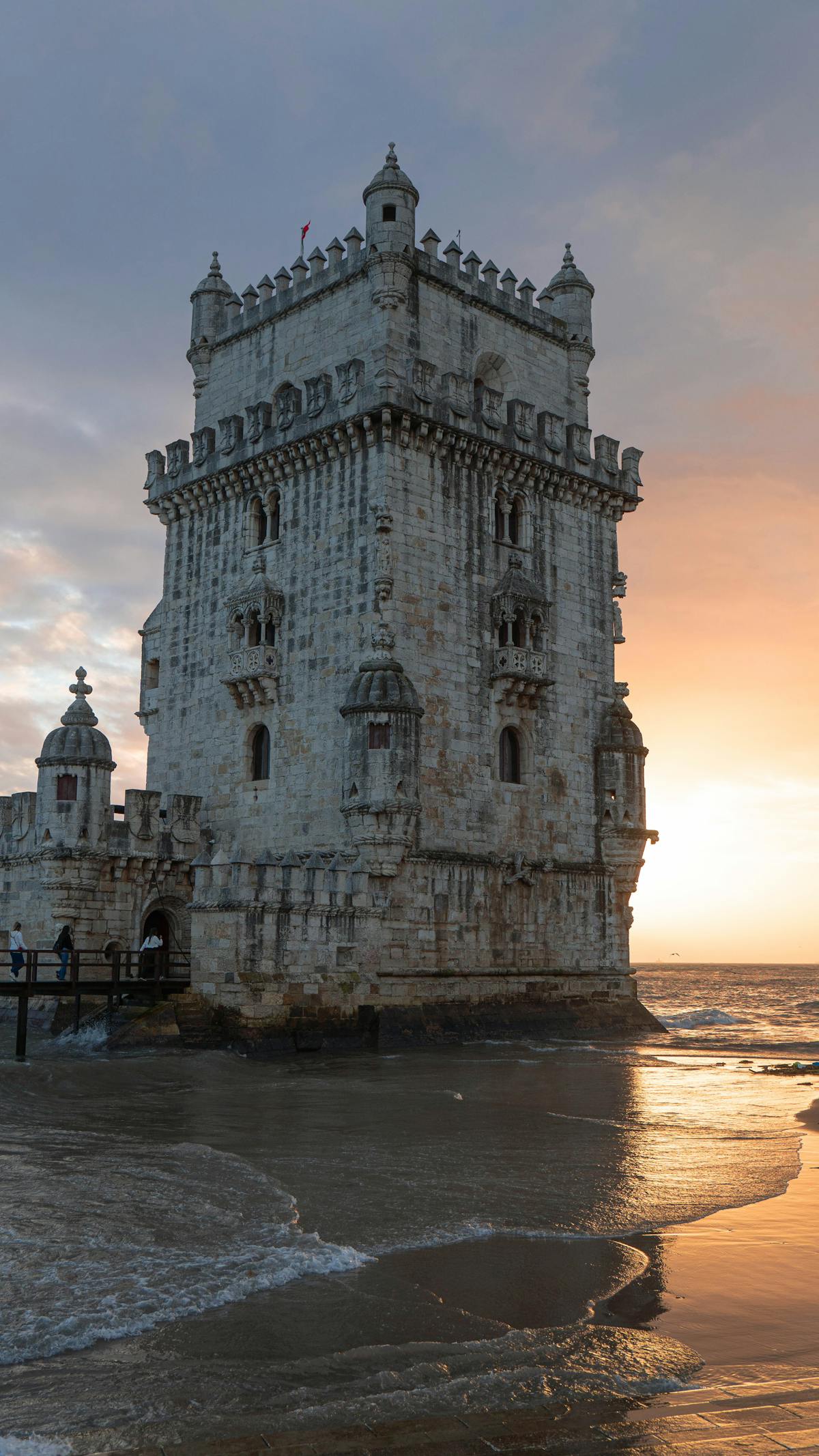 Belem Tower against sunset on Lisbon coastline