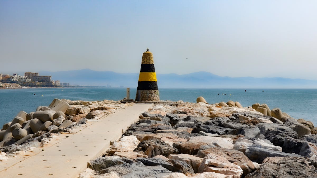 Tranquil seacoast in Benalmadena with a maritime bollard and Mediterranean Sea