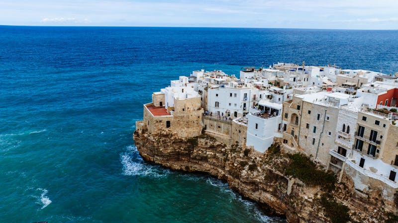 Aerial view of Polignano a Mare old town on the cliff edge with the Adriatic Sea below