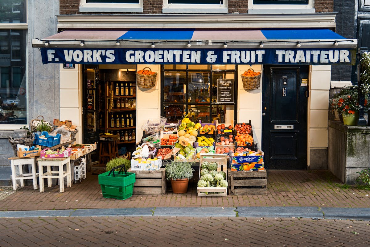 Colorful fruit and vegetable display outside a traditional Amsterdam grocery store