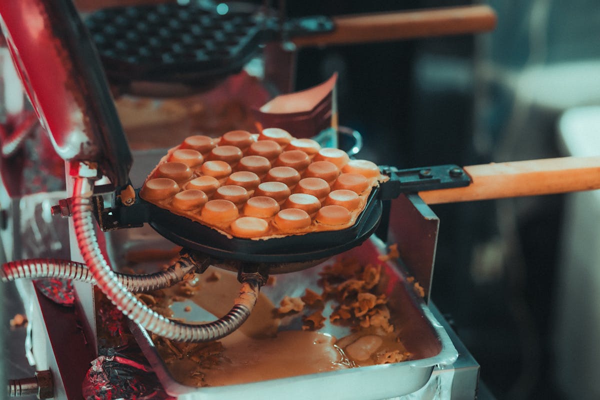 Close-up of golden waffles baking in a hot waffle iron