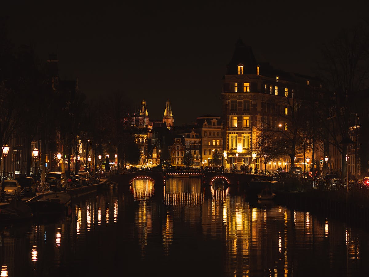 Beautiful nighttime view of Amsterdam illuminated canals and historic buildings