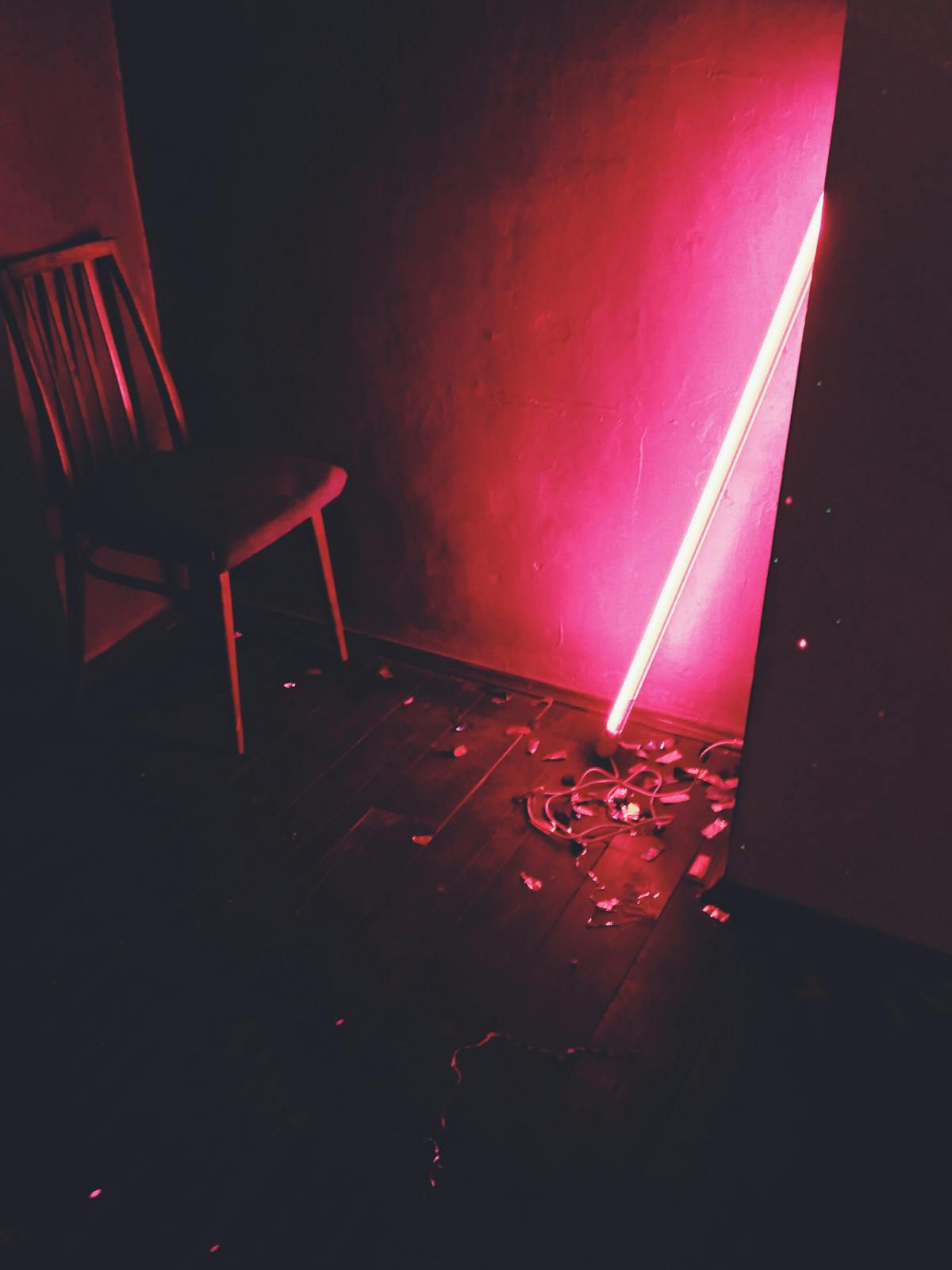 A dimly lit room with dramatic red neon lighting