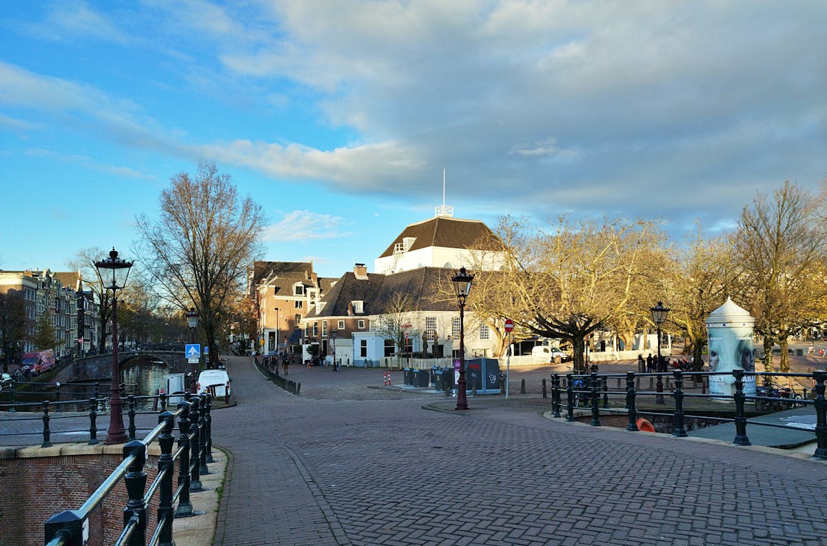 Charming Amsterdam street view with canal and typical Dutch houses