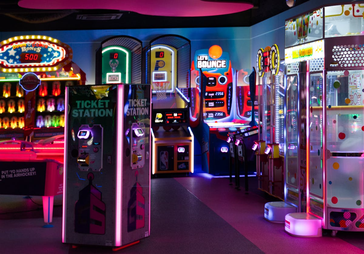 Brightly lit arcade games and ticket stations in an indoor entertainment center