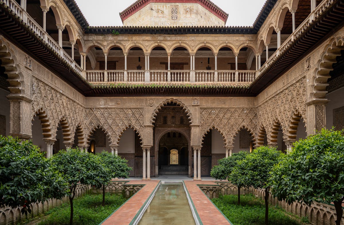 Patio with Moorish double arches and intricate plasterwork in Seville