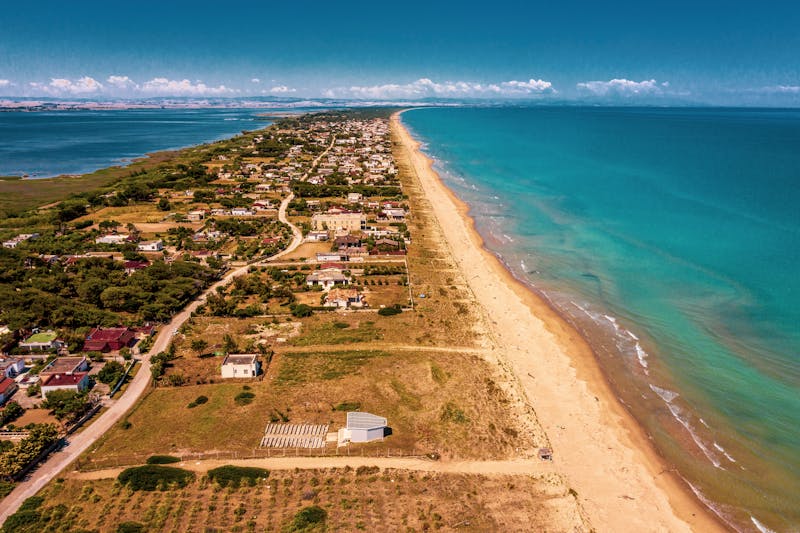 Aerial view of a Puglia coastal town with dramatic coastline and the Adriatic Sea