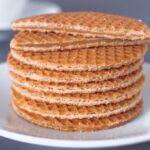 Stack of freshly made Dutch stroopwafels on a white plate