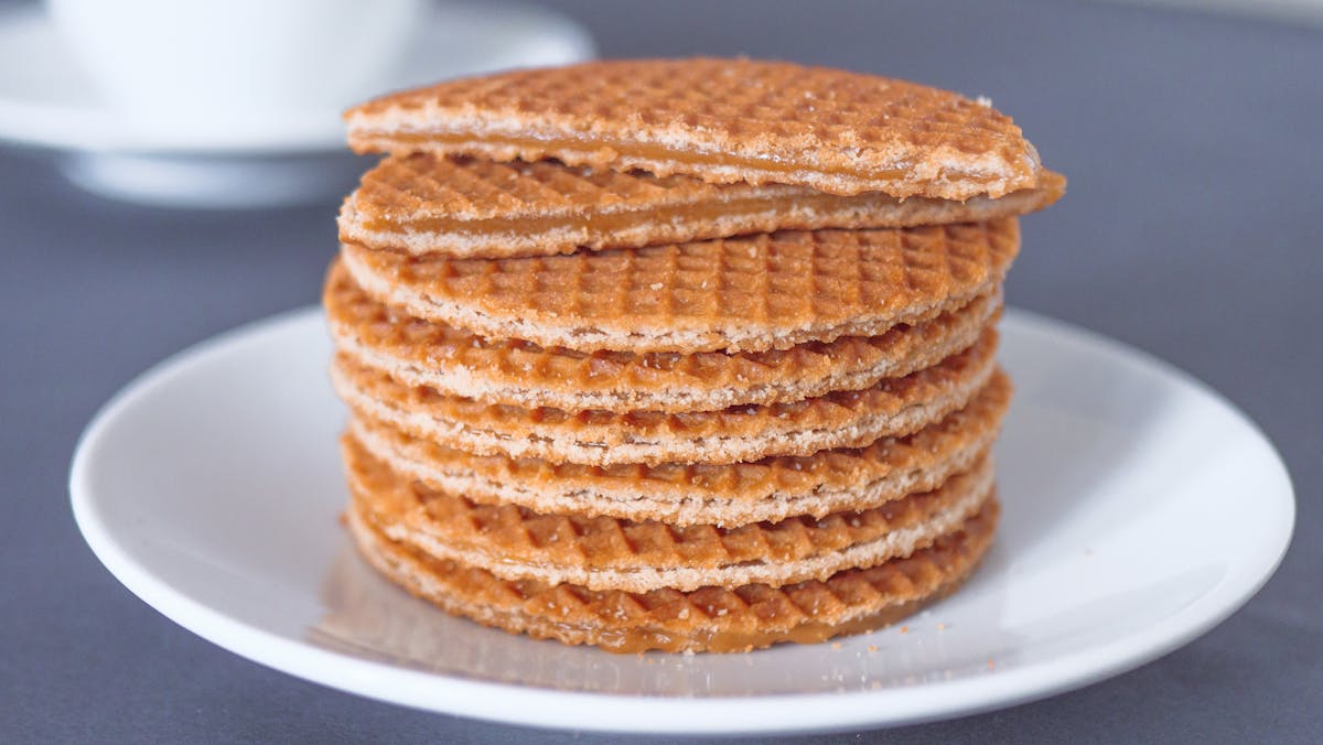 Stack of freshly made Dutch stroopwafels on a white plate