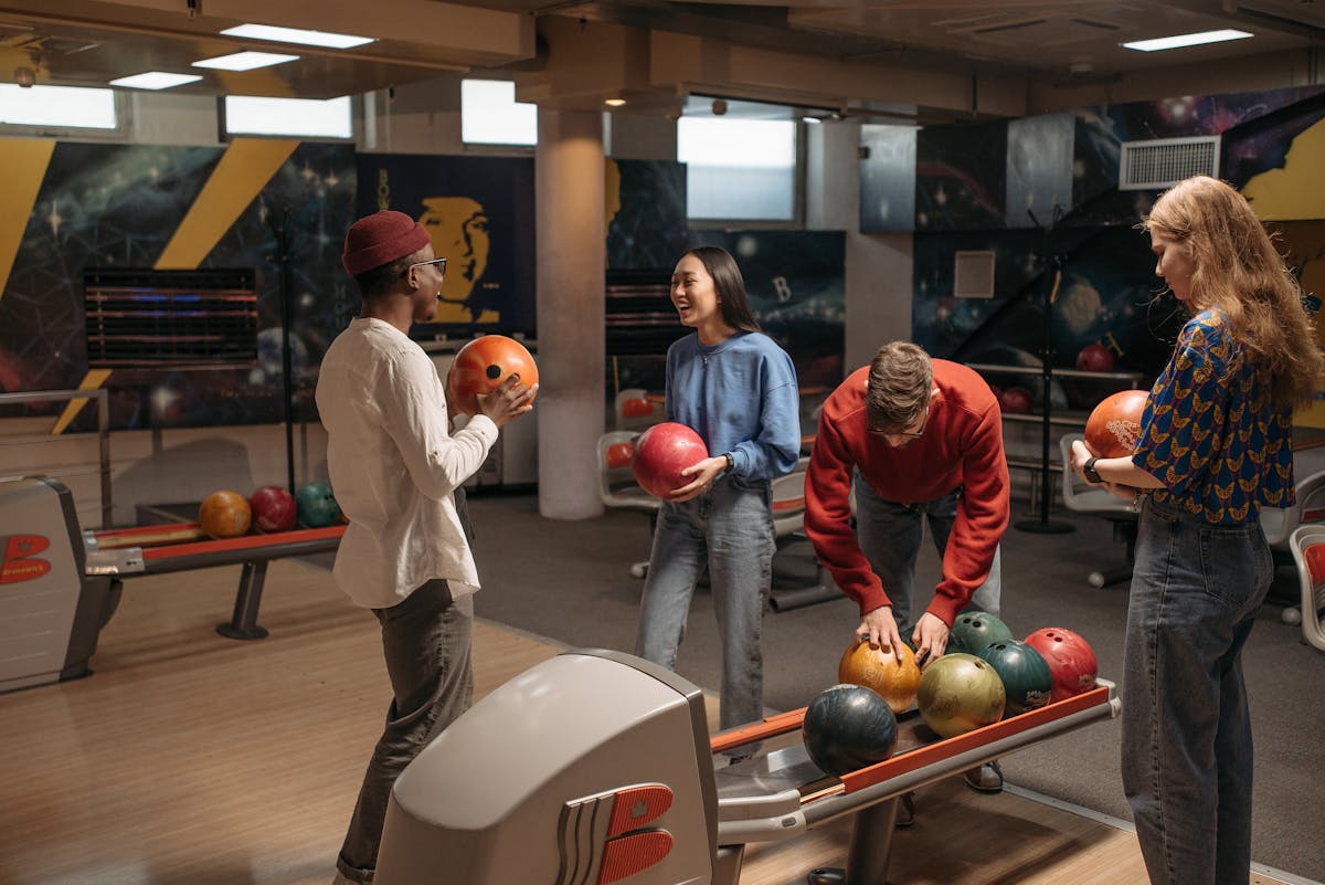 Group of friends enjoying bowling at an indoor bowling alley