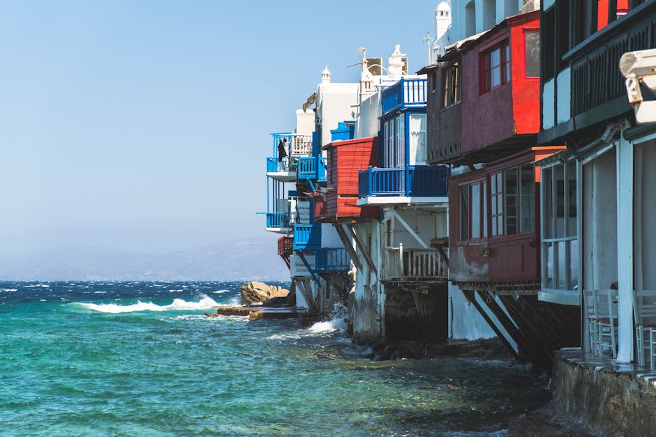 Colorful houses along the Mykonos seaside with clear blue water