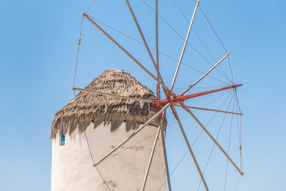 White windmill against blue sky showing traditional Mykonos architecture
