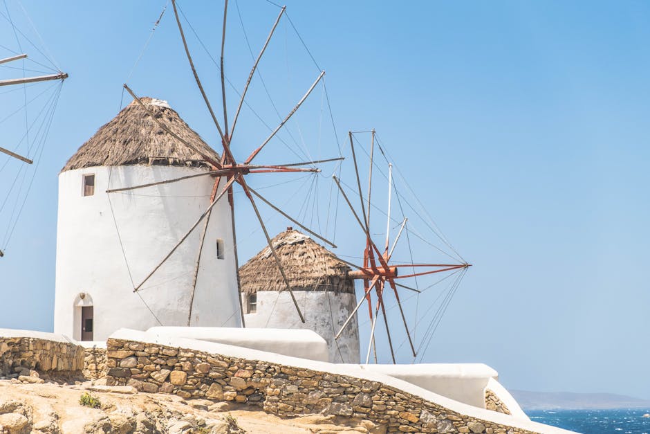Traditional windmills of Mykonos against a clear blue sky