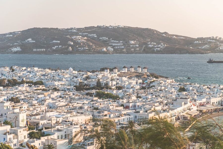 Aerial view of Mykonos Town with windmills and Aegean Sea backdrop