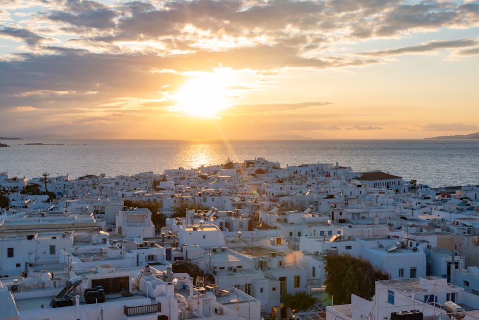 Aerial view of Mykonos Town with whitewashed buildings at sunset
