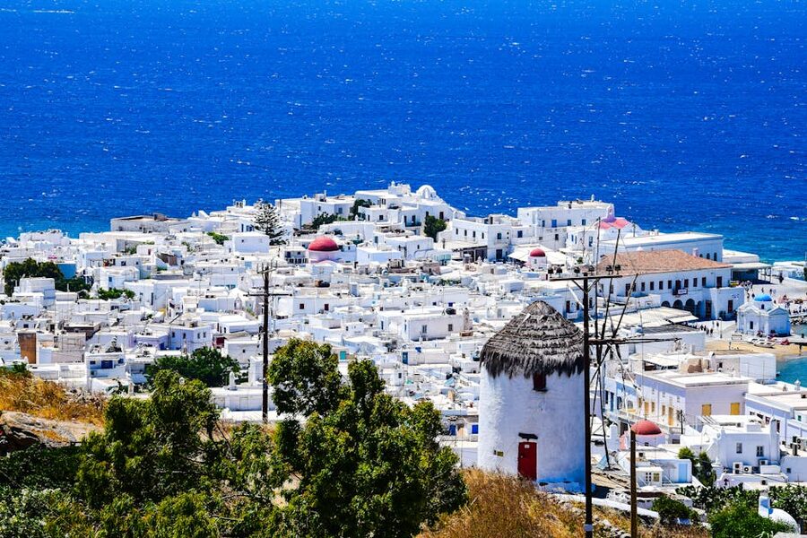 Aerial view of whitewashed buildings in Mykonos Town overlooking the Aegean