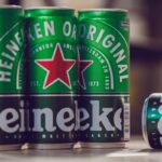 Close-up of Heineken beer cans showing the iconic green and red branding