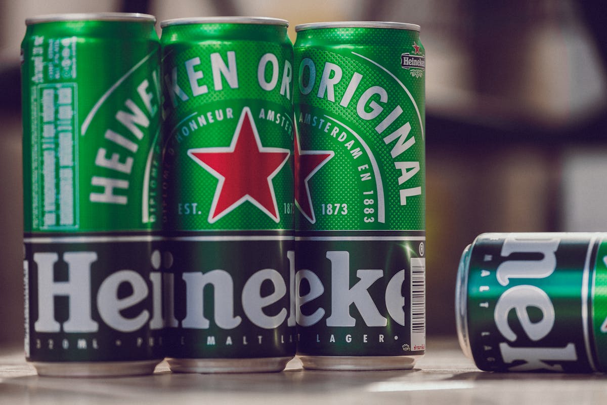 Close-up of Heineken beer cans showing the iconic green and red branding