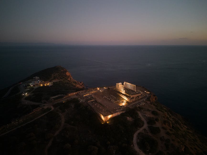 Aerial shot of the Temple of Poseidon at twilight overlooking the sea