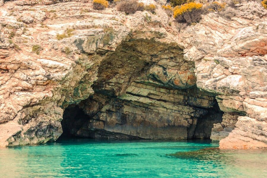 Stunning sea cave in Greece with turquoise waters and rugged cliffs