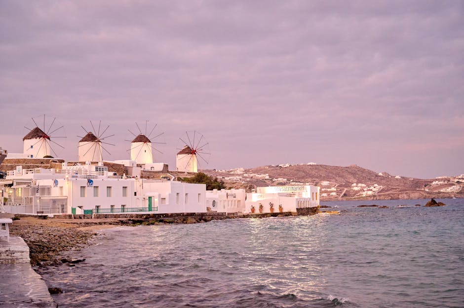 Famous windmills of Mykonos at sunset by the sea