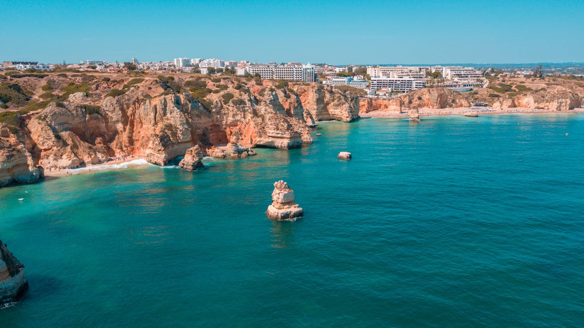 Aerial view of cliffs and turquoise waters in Algarve Portugal