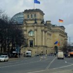Reichstag Building with German and EU flags flying in Berlin