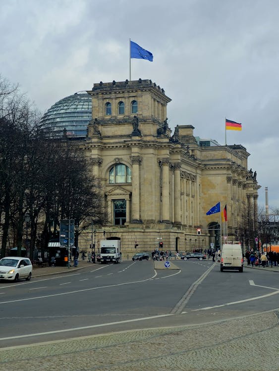 Reichstag Building with German and EU flags flying in Berlin