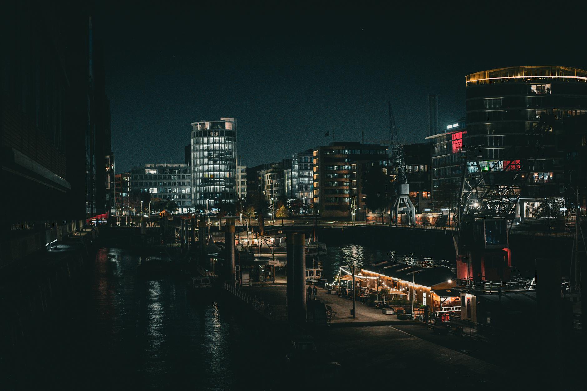 Night view of Hamburg port with city lights reflecting on water