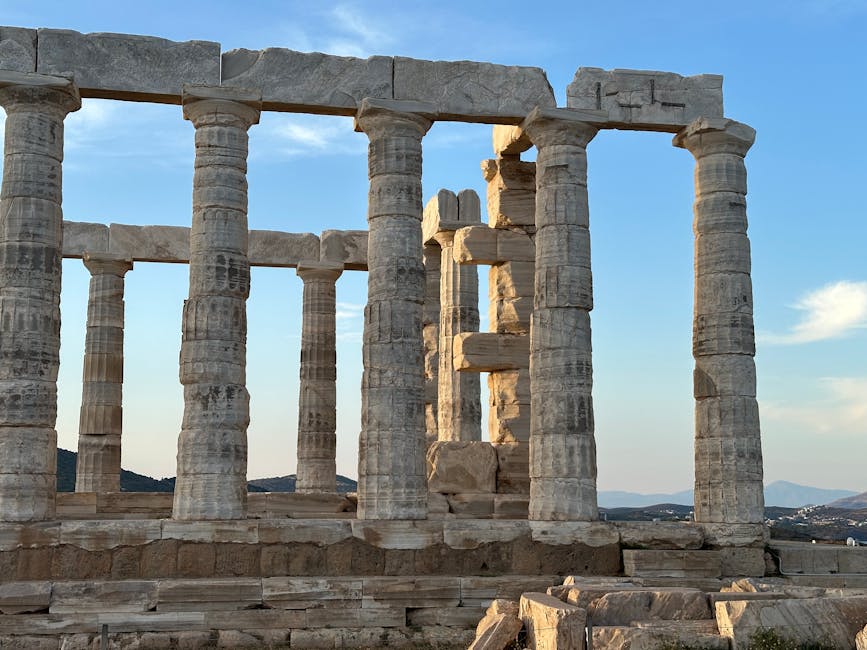 Ancient Temple of Poseidon in Sounion, Greece, illuminated by warm sunset light