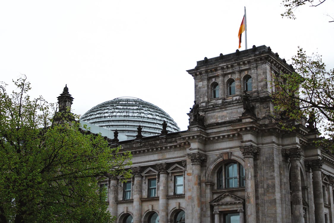 Reichstag Building exterior with glass dome and German flag
