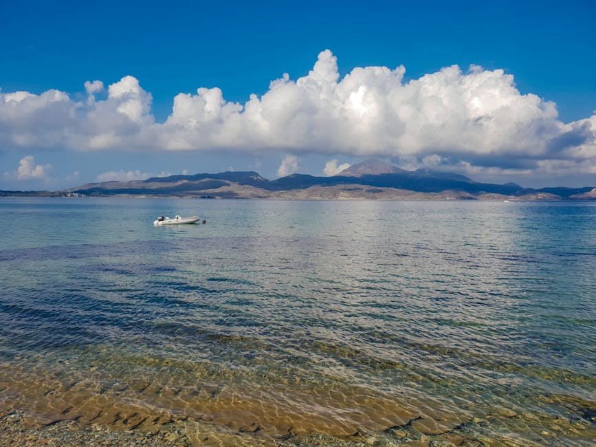 Boat floating on the Aegean Sea with a Greek island in the background