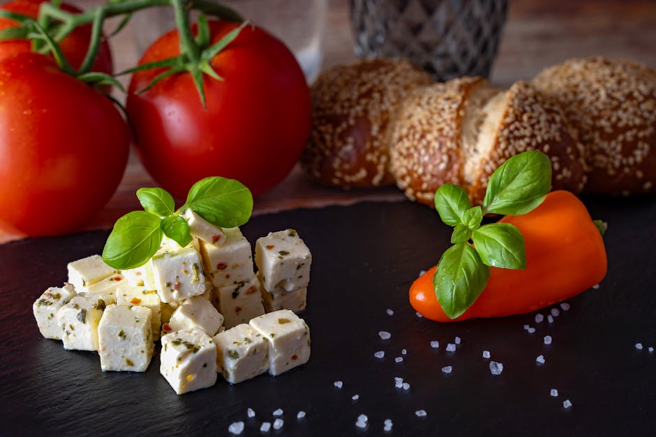 Mediterranean platter featuring feta, tomatoes, bread, and peppers