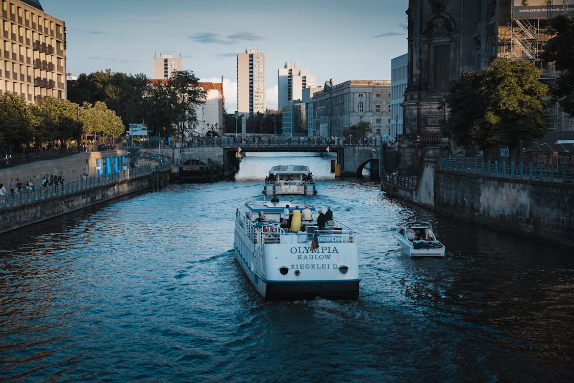 Berlin canal with boats and modern architecture along waterfront