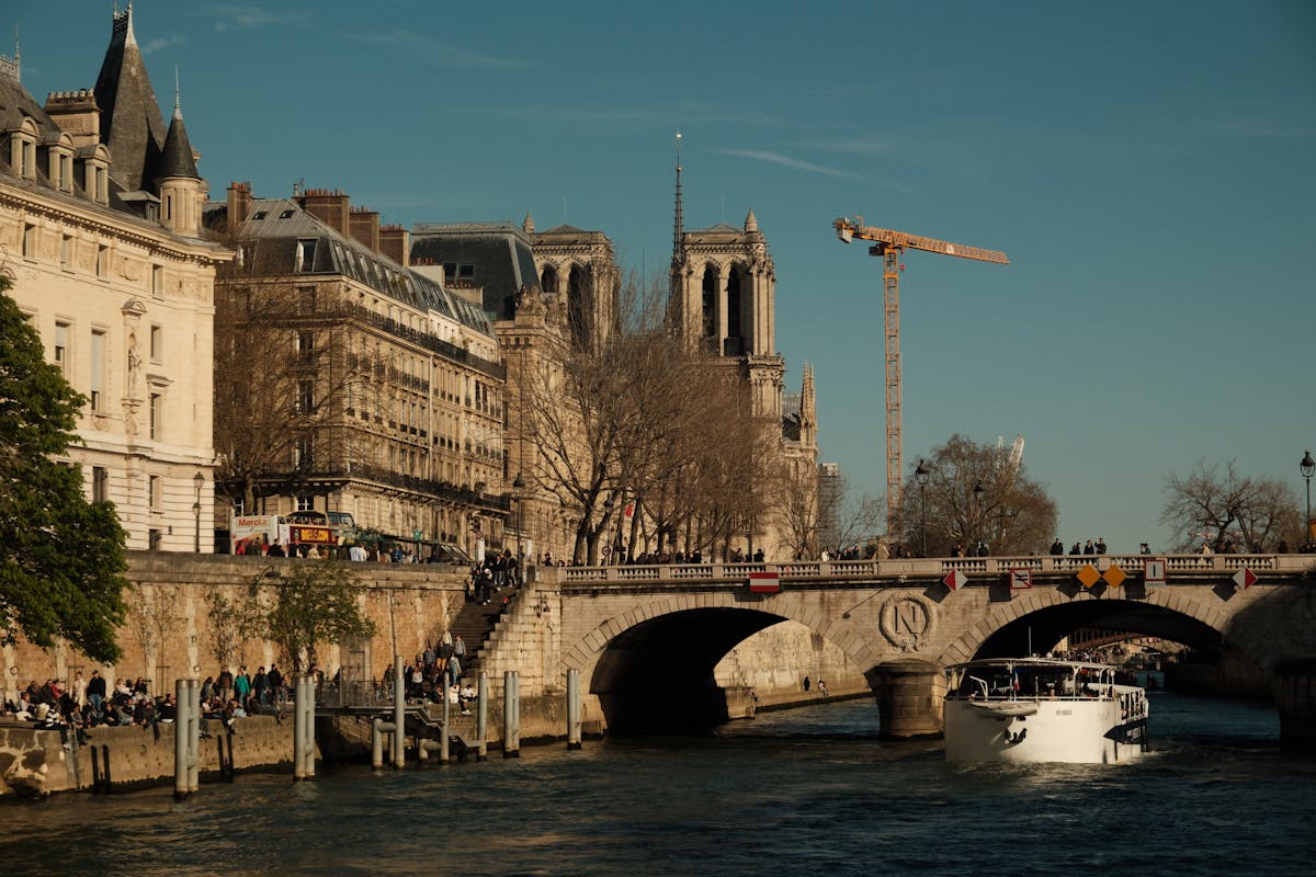 Notre-Dame Cathedral beside the Seine River on a sunny day in Paris