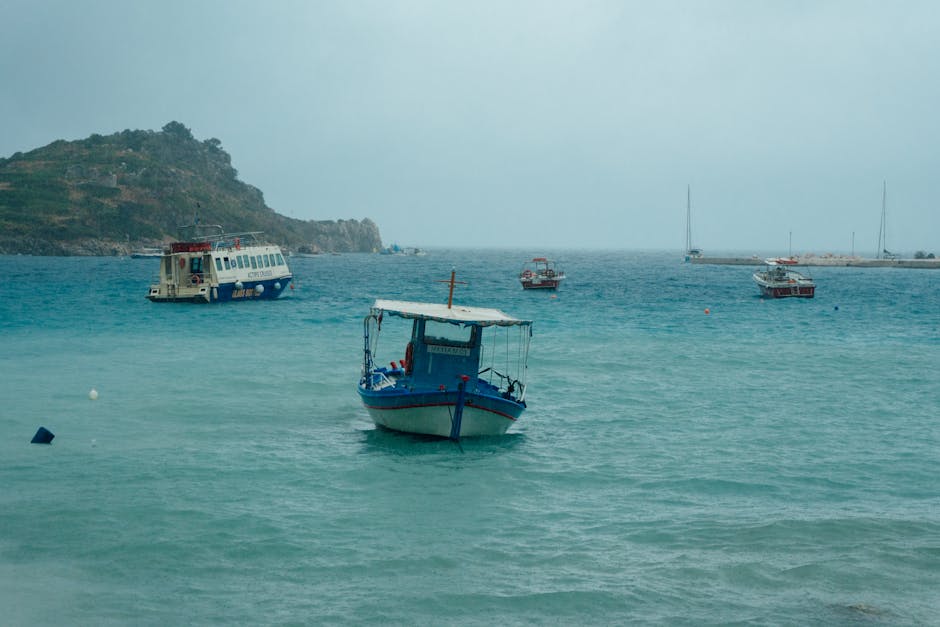 Small boats anchored in clear blue waters off the coast of Zakynthos